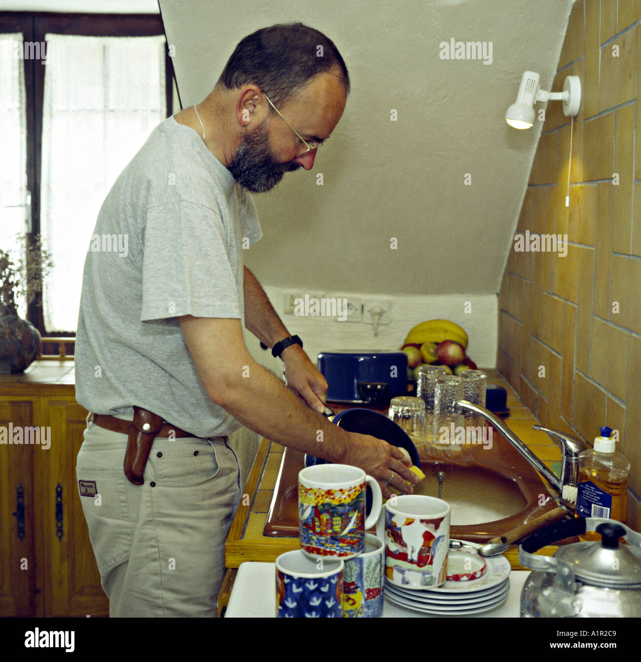 man by housekeeping house man washing up MR Stock Photo - Alamy