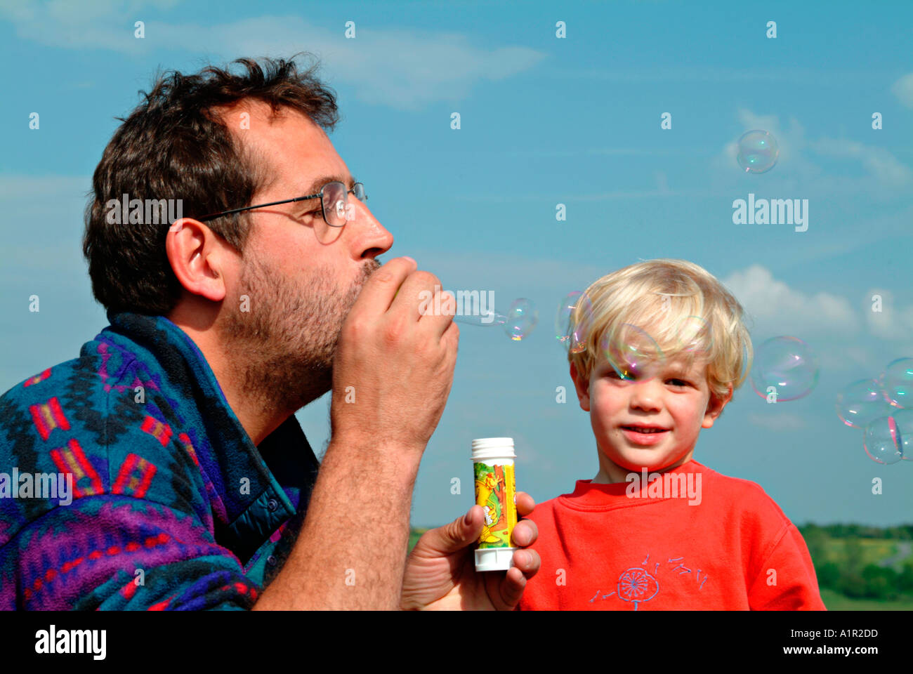 father and his son making soap bubbles MR Stock Photo - Alamy