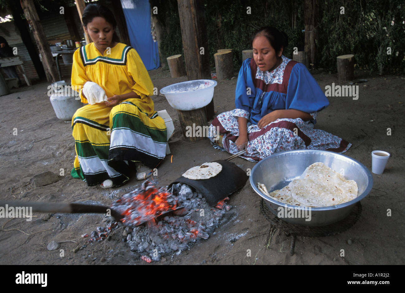 On the first day of her Sunrise Dance an Apache girl and her assistant ...