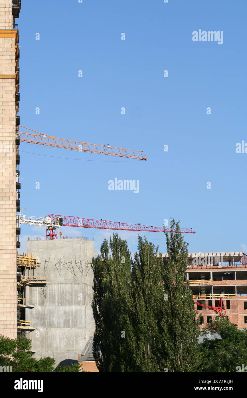 Construction site with cranes and unfinished buildings in Kyiv under a ...