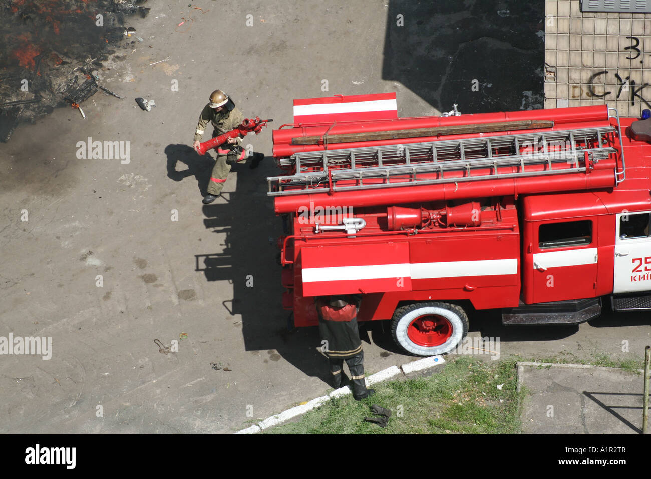 Firefighters in Kyiv extinguishing a fire with a red fire truck and equipment Stock Photo - Alamy