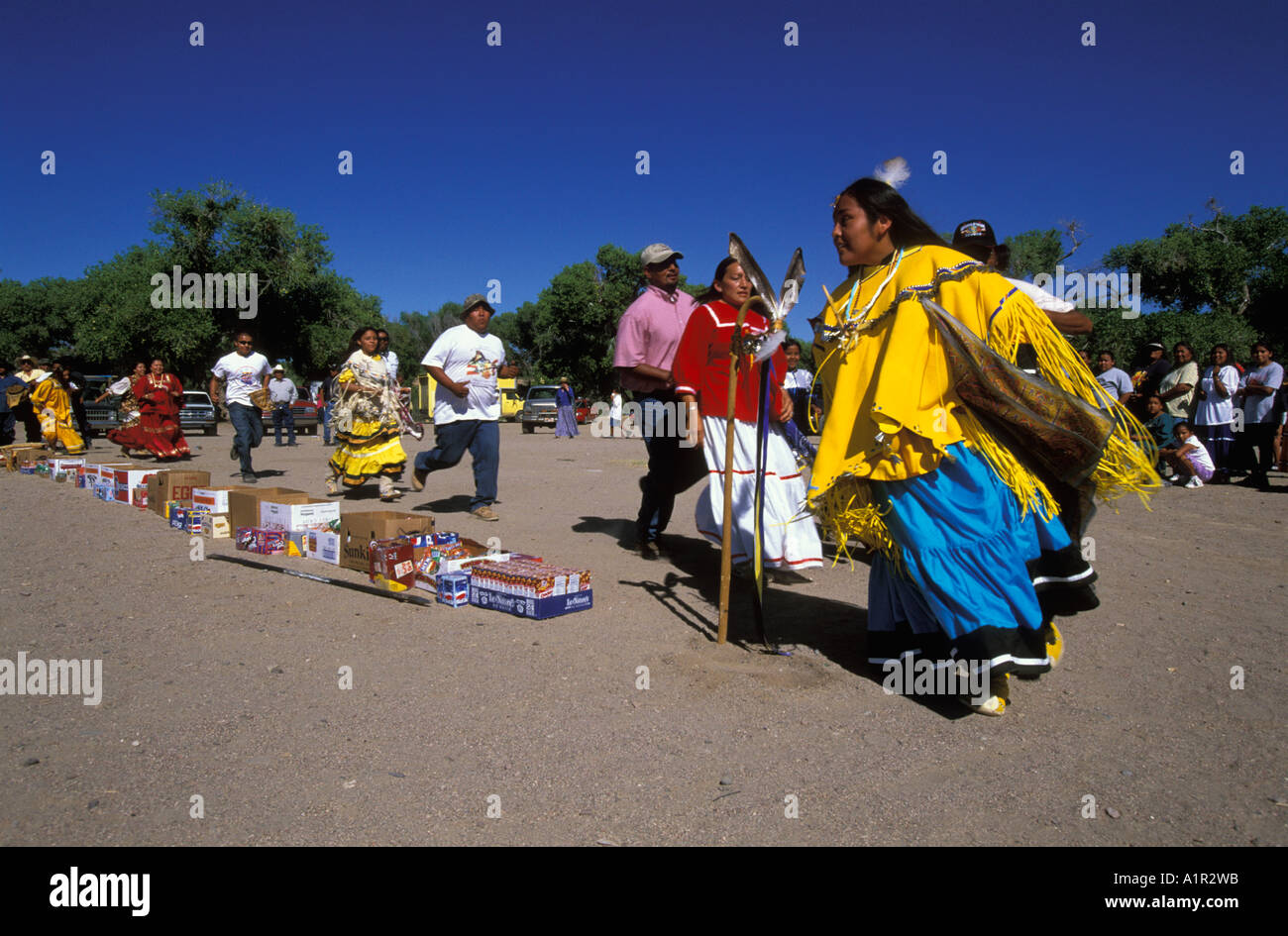An Apache girl dressed in buckskin dress runs during her Sunrise Dance ...
