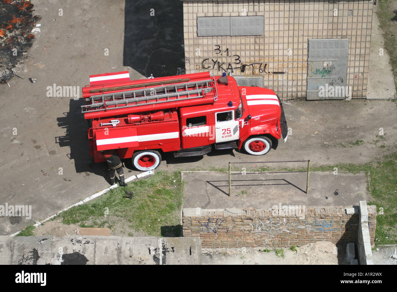Firefighters in Kyiv extinguishing a fire with a red fire truck and ...