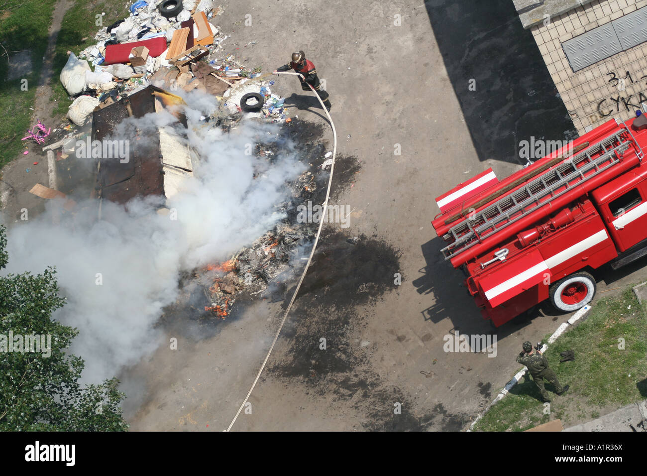 Firemen extinguishing fire on a dump Stock Photo - Alamy