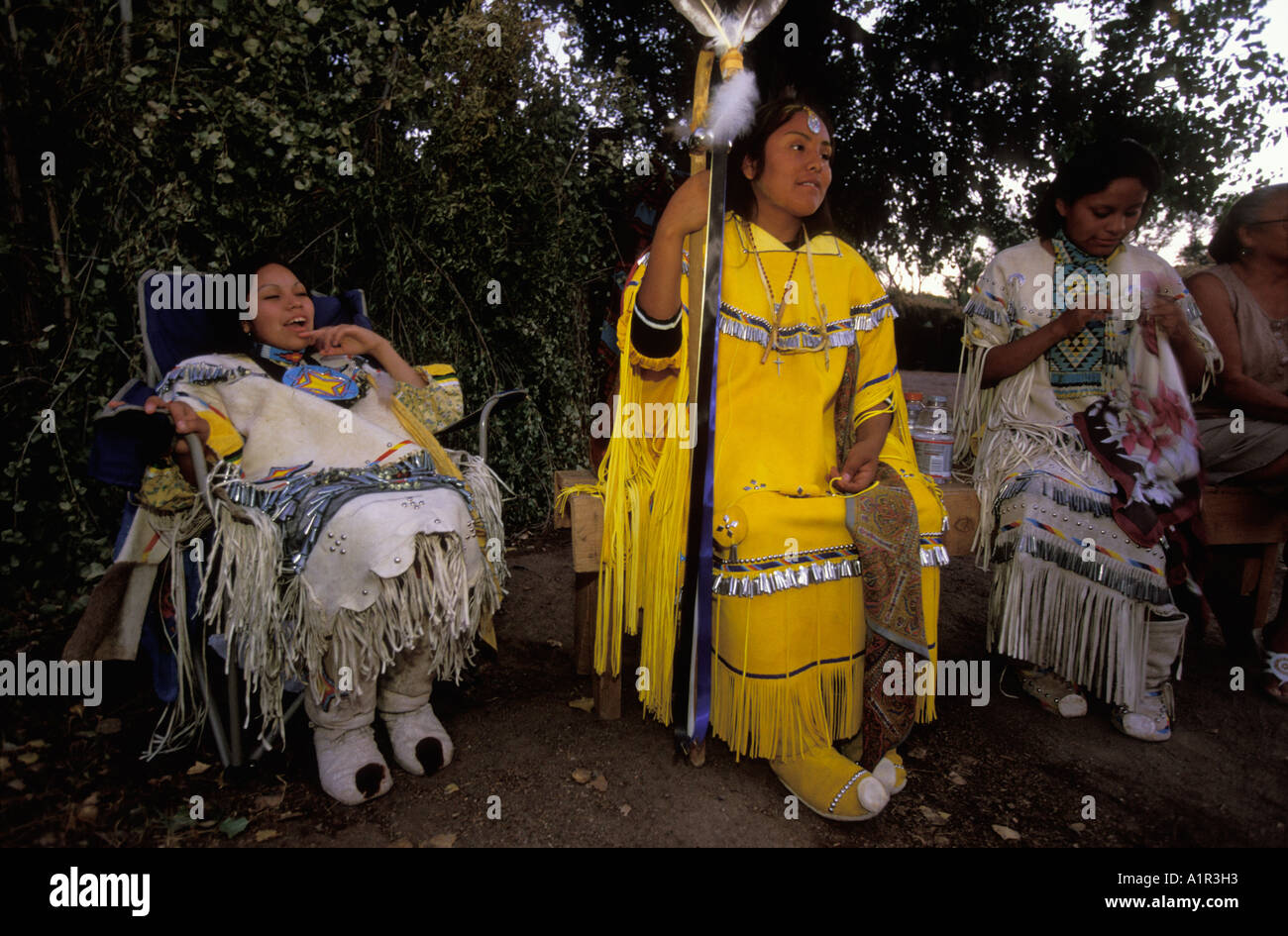 Apache girl and two cousins have a rest during her Sunrise Dance on the ...