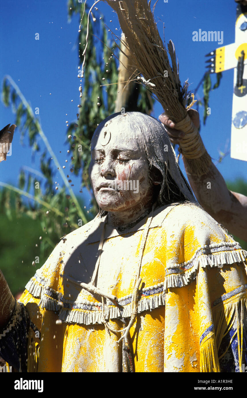 An Apache girl is painted with sacred clay and corn meal during her ...