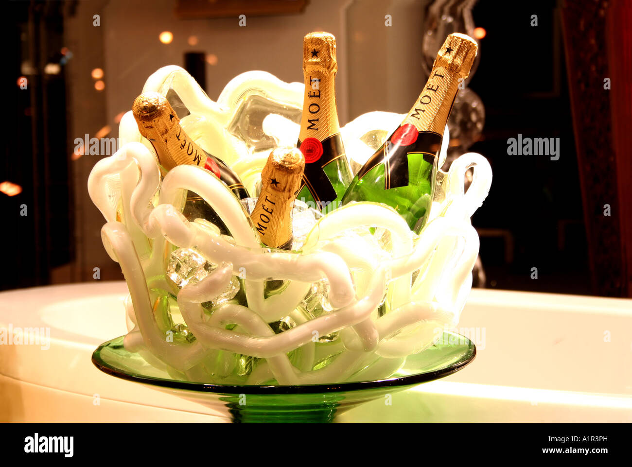 Elegant display of Moet champagne bottles in a decorative ice bucket ...