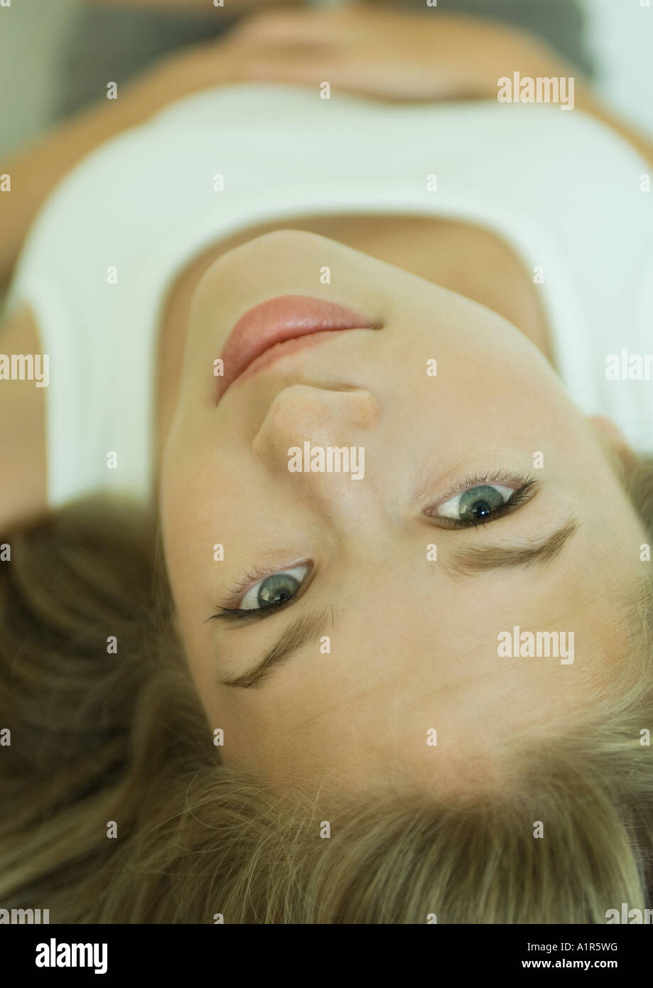 Young woman lying on back, close-up of face, upside down Stock Photo ...