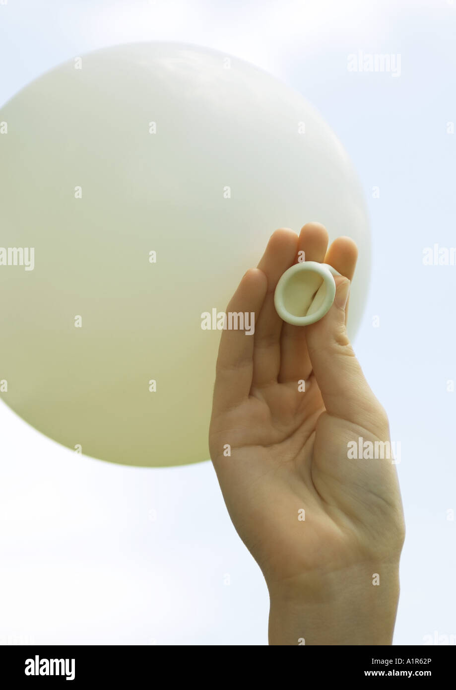 Hand holding up balloon Stock Photo - Alamy