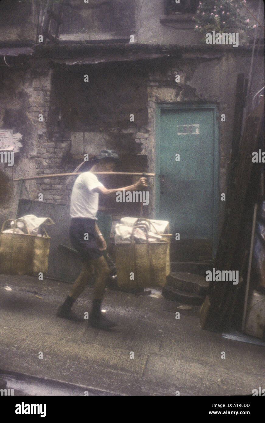 Hong Kong Man Carrying Baskets Stock Photo - Alamy