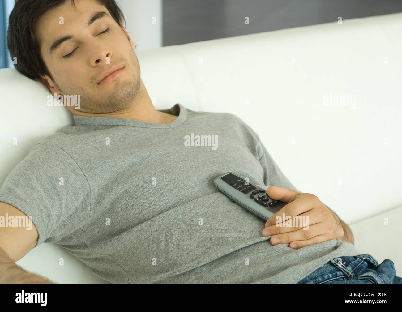Man casually holds tv remote hi-res stock photography and images - Alamy