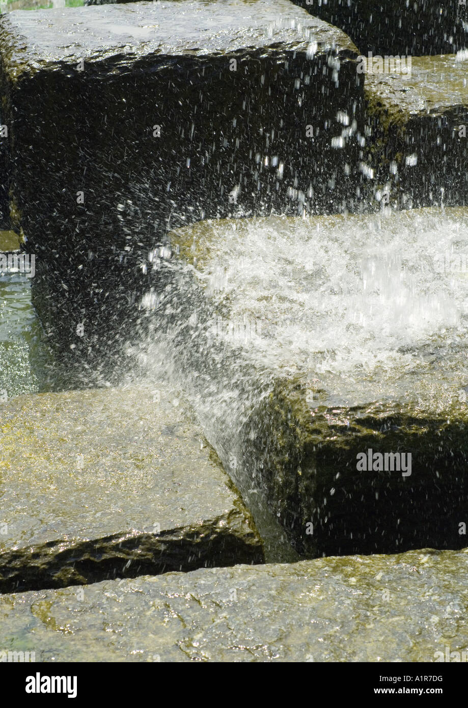 Water splashing onto stone block Stock Photo - Alamy