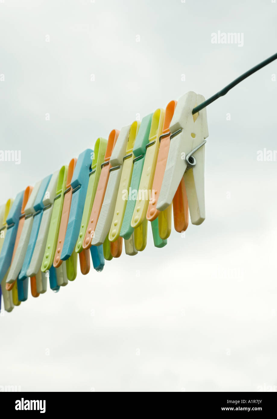 Clothes pegs hanging on clothesline Stock Photo - Alamy