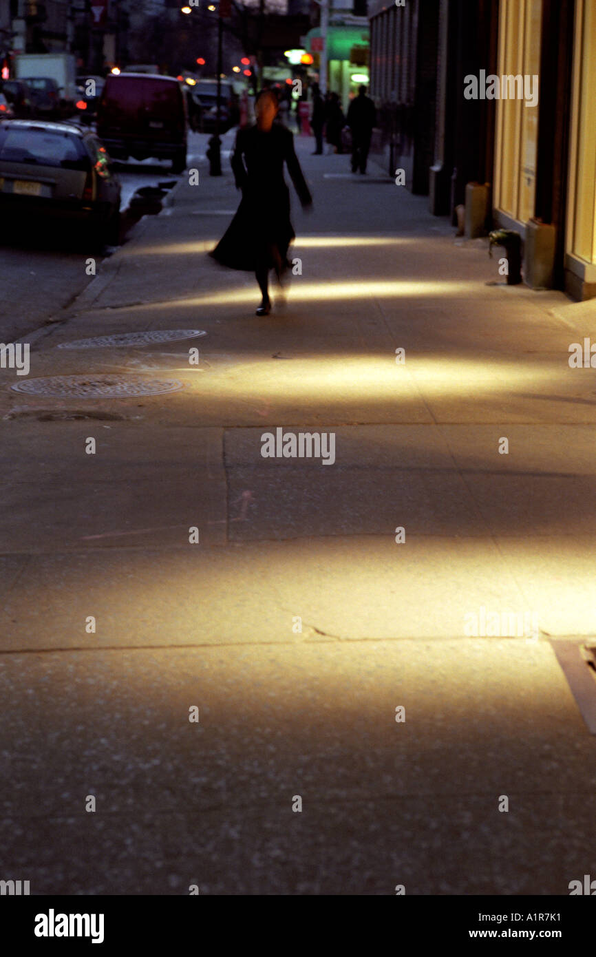 Woman running across the street light at NYC Stock Photo - Alamy