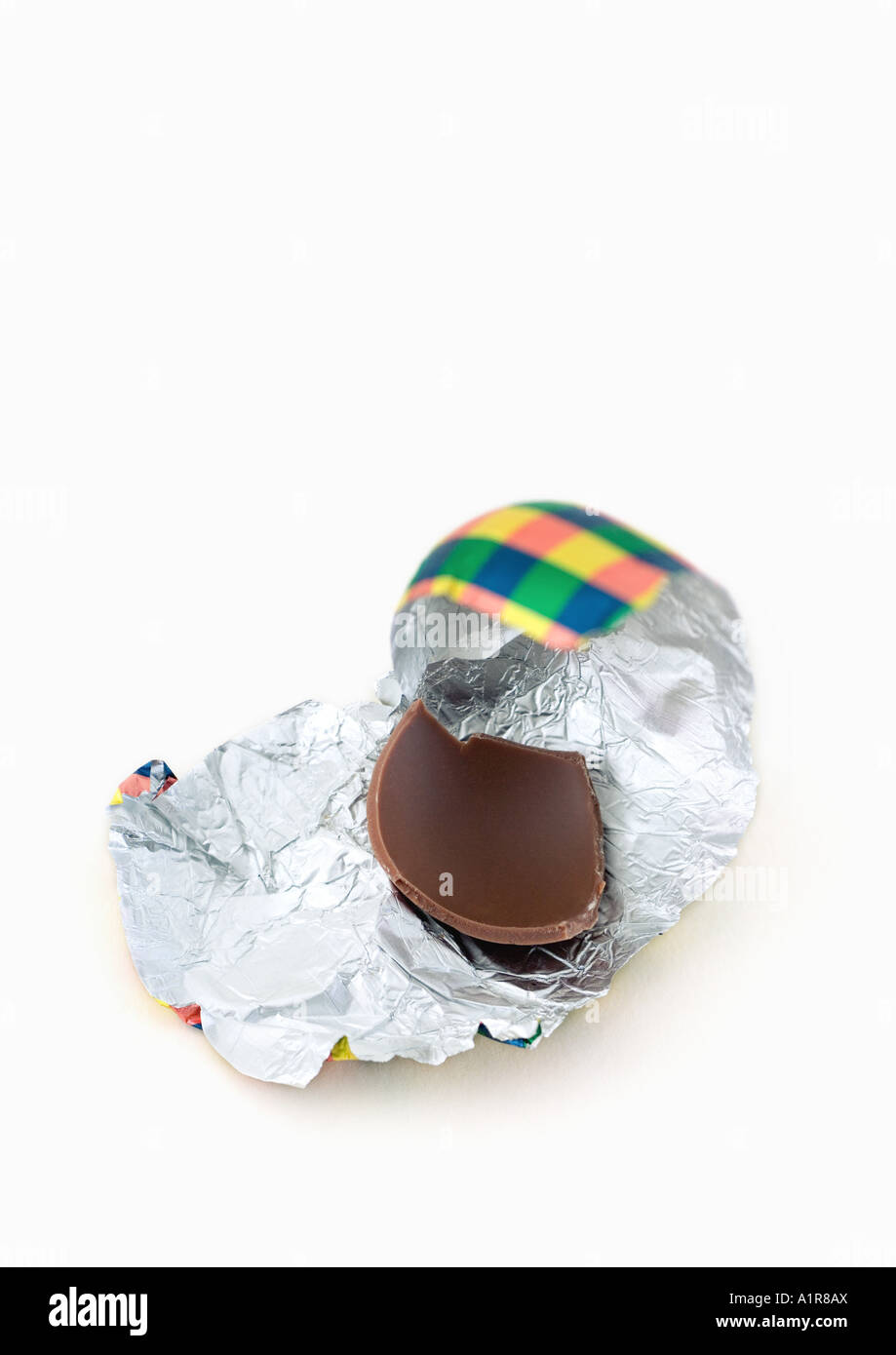 Piece of chocolate egg on wrapper Stock Photo - Alamy