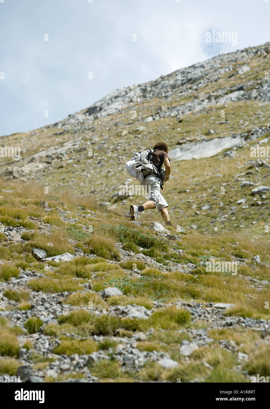 Hiker running uphill Stock Photo - Alamy