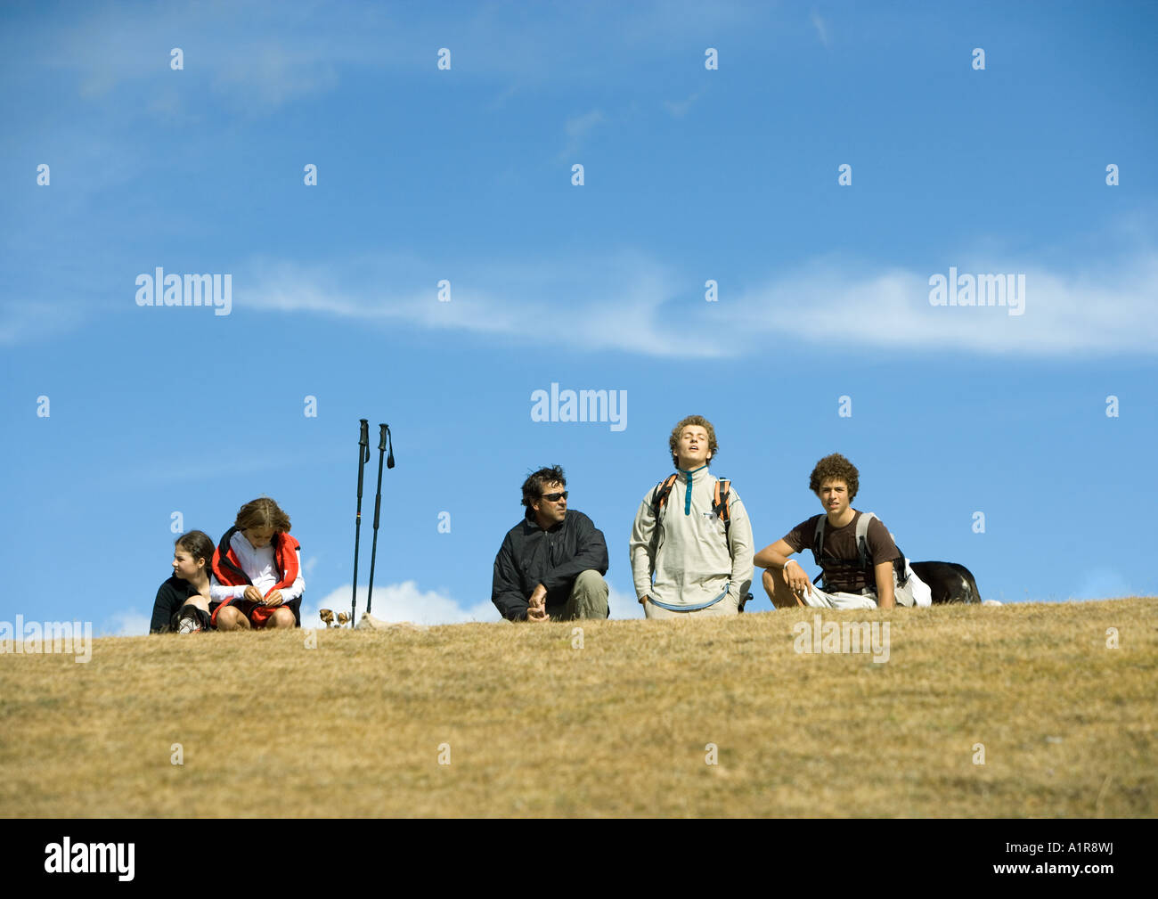 Hikers taking break, one with eyes closed and head back Stock Photo - Alamy