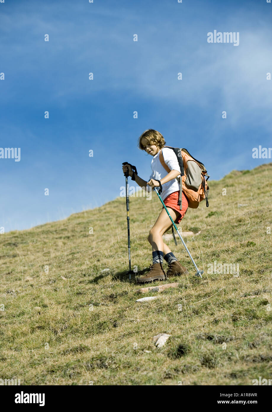 Girl hiking down mountain Stock Photo - Alamy