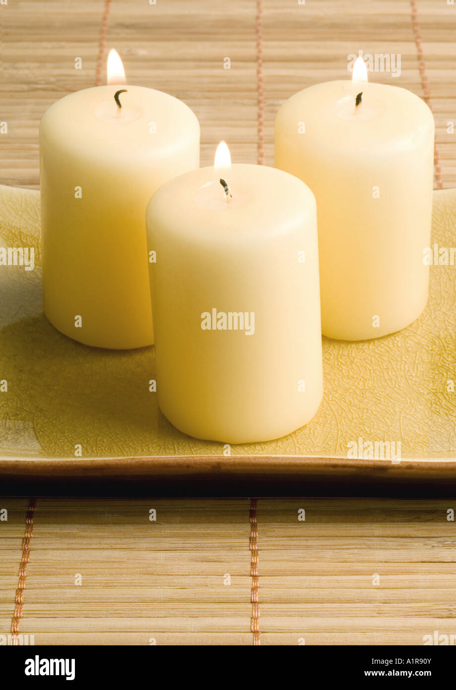 Three lit candles Stock Photo - Alamy