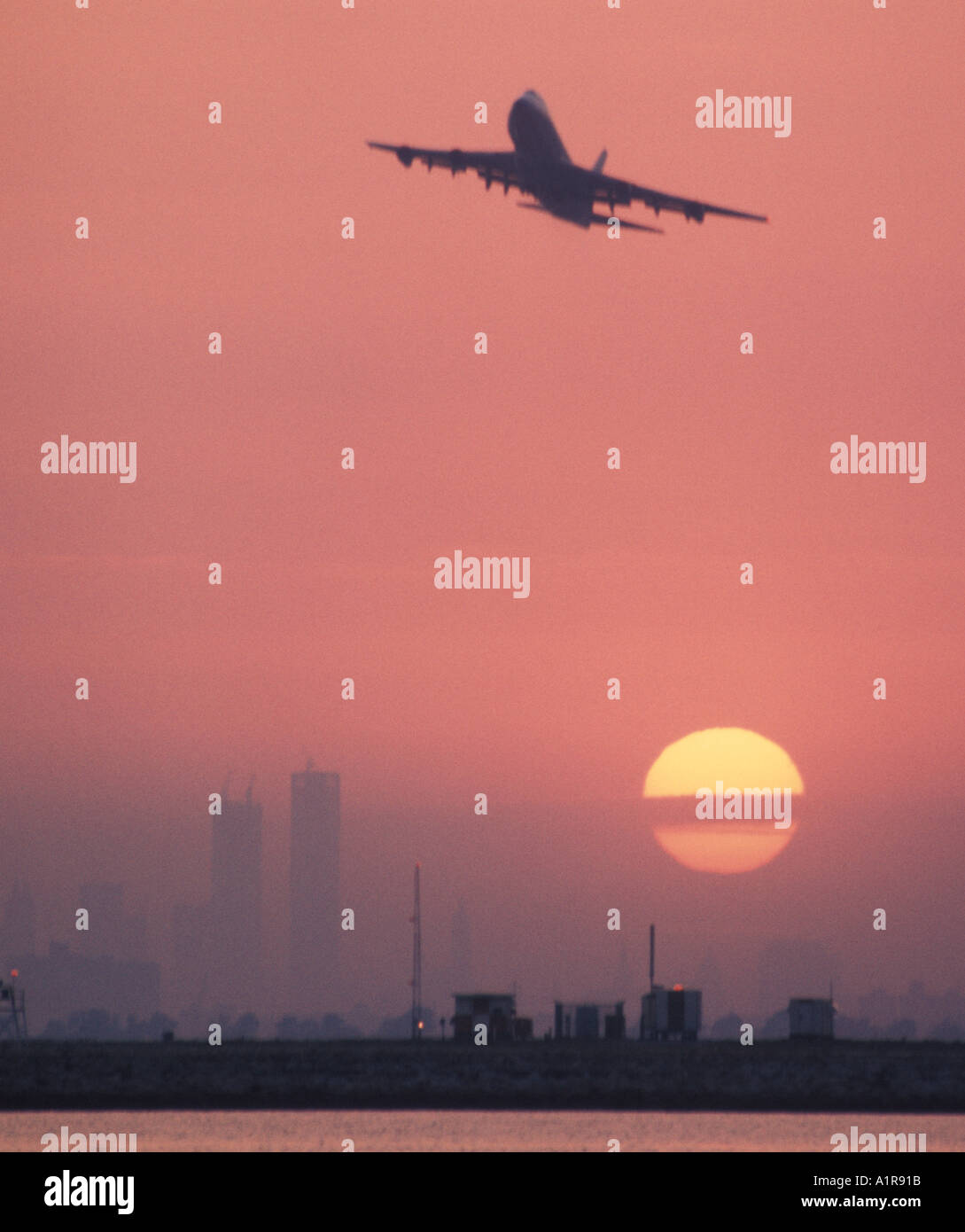 commercial jet airplane taking off at sunset from New York Stock Photo ...
