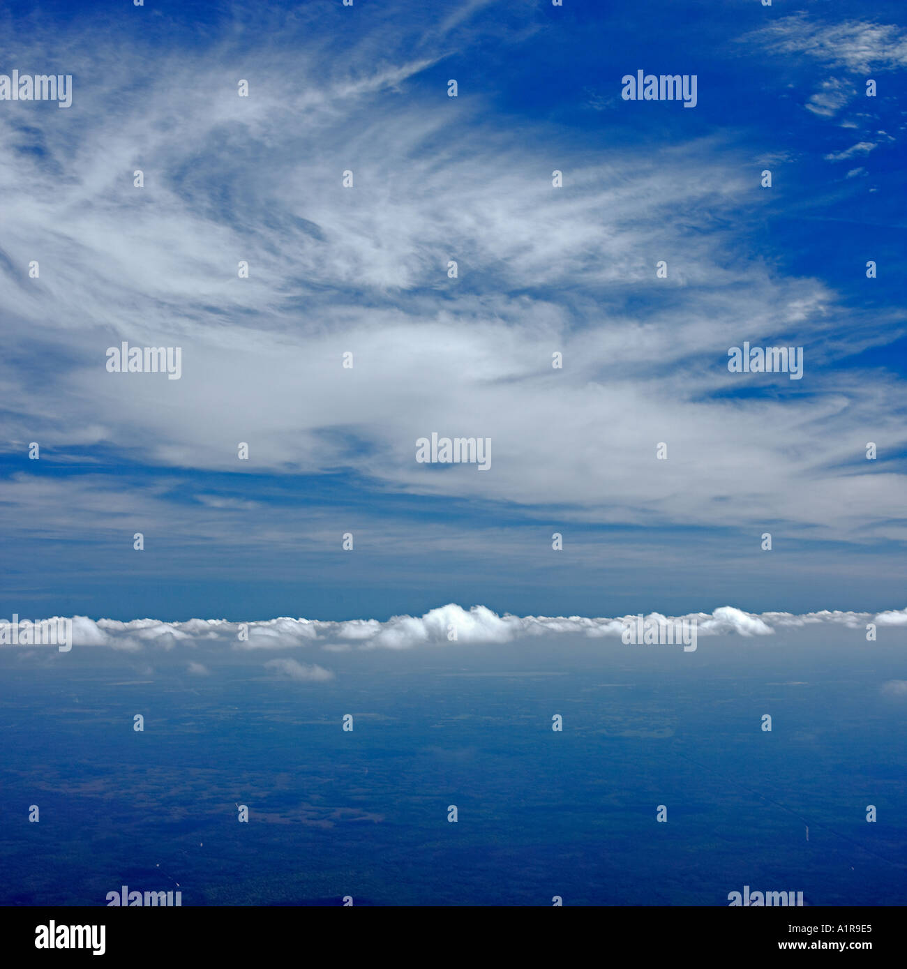 Aerial view above cumulus and below stratus cloud formations against ...