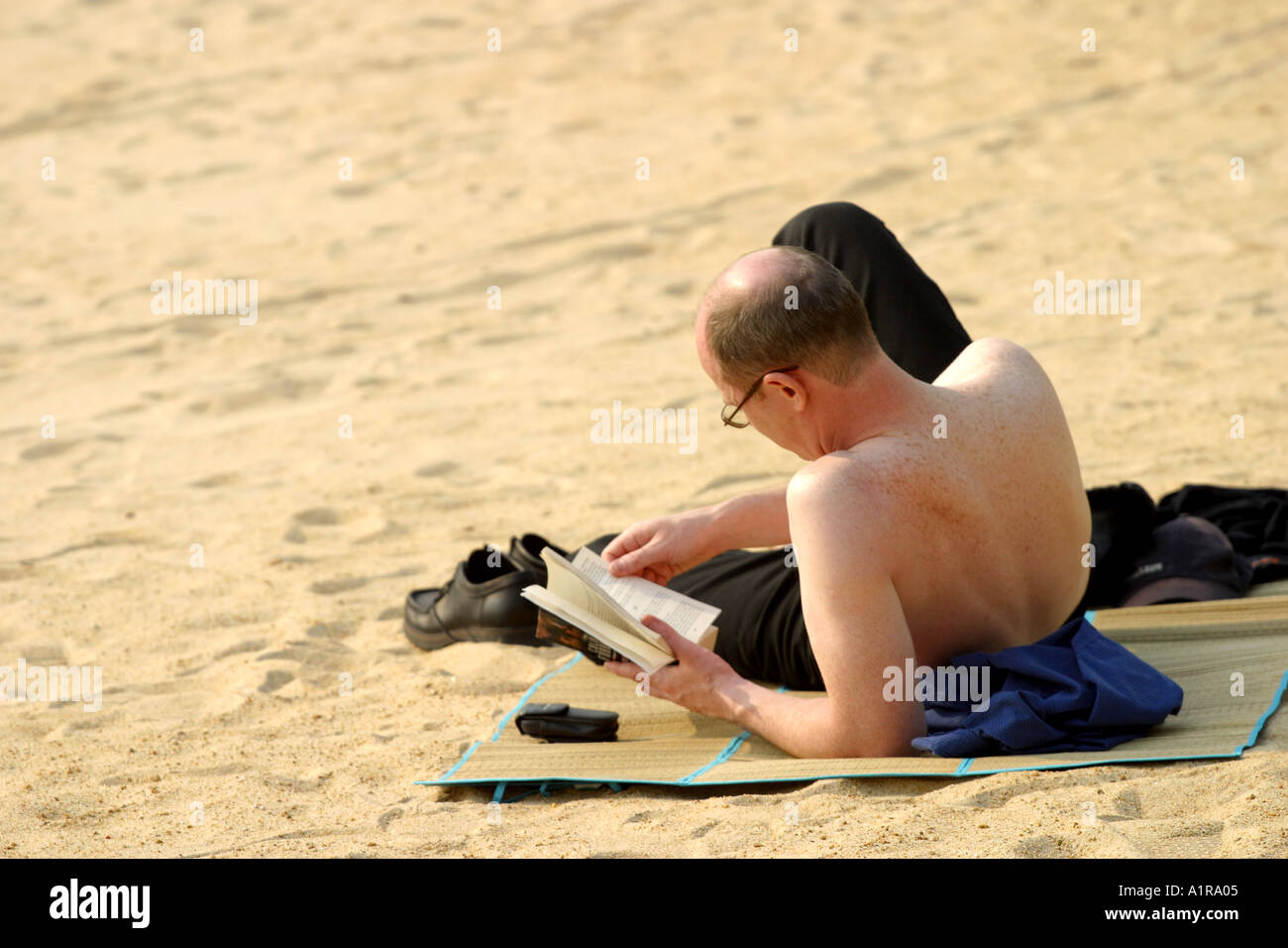 Man take sunbath on the beach UK thailand relax restore Stock Photo - Alamy