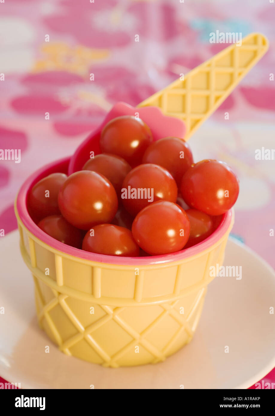 Ice cream cone bowl containing cherry tomatoes Stock Photo - Alamy