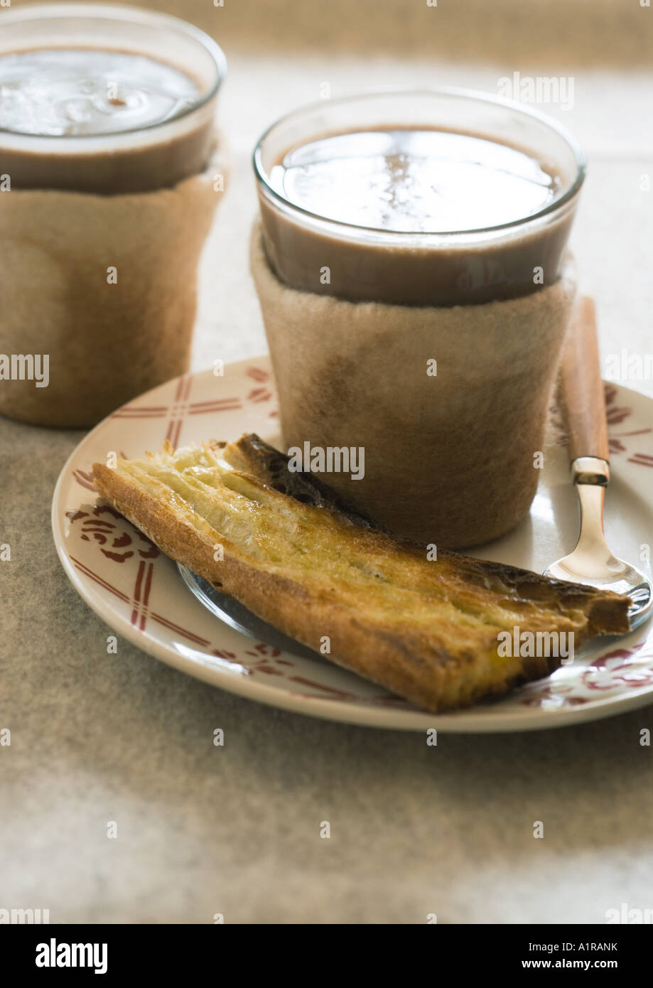 Two cups of coffee and piece of toast Stock Photo - Alamy