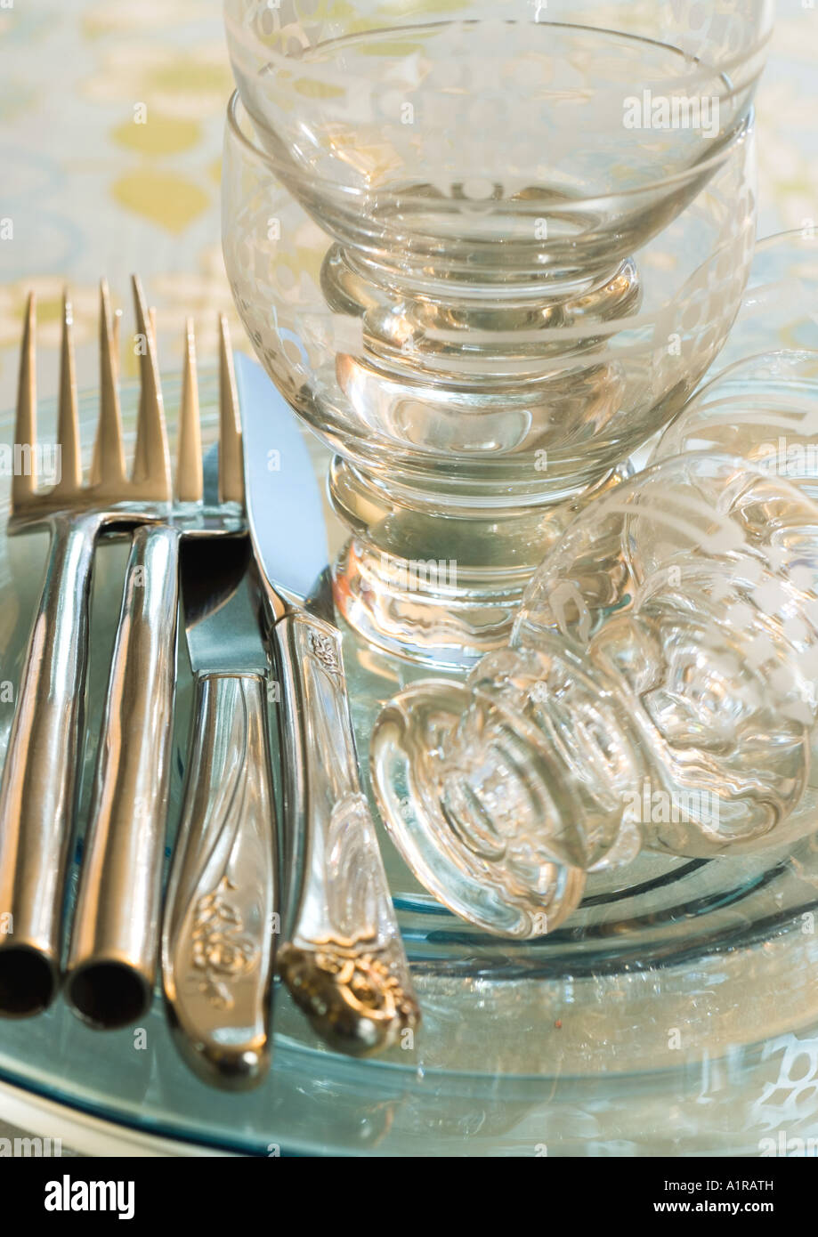 Stack of plates, silverware and glasses Stock Photo - Alamy