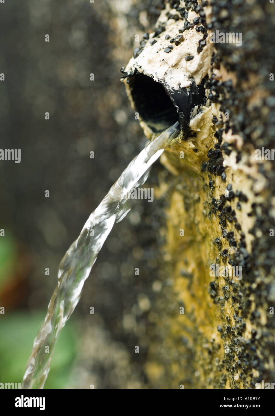 Water running out of pipe Stock Photo - Alamy