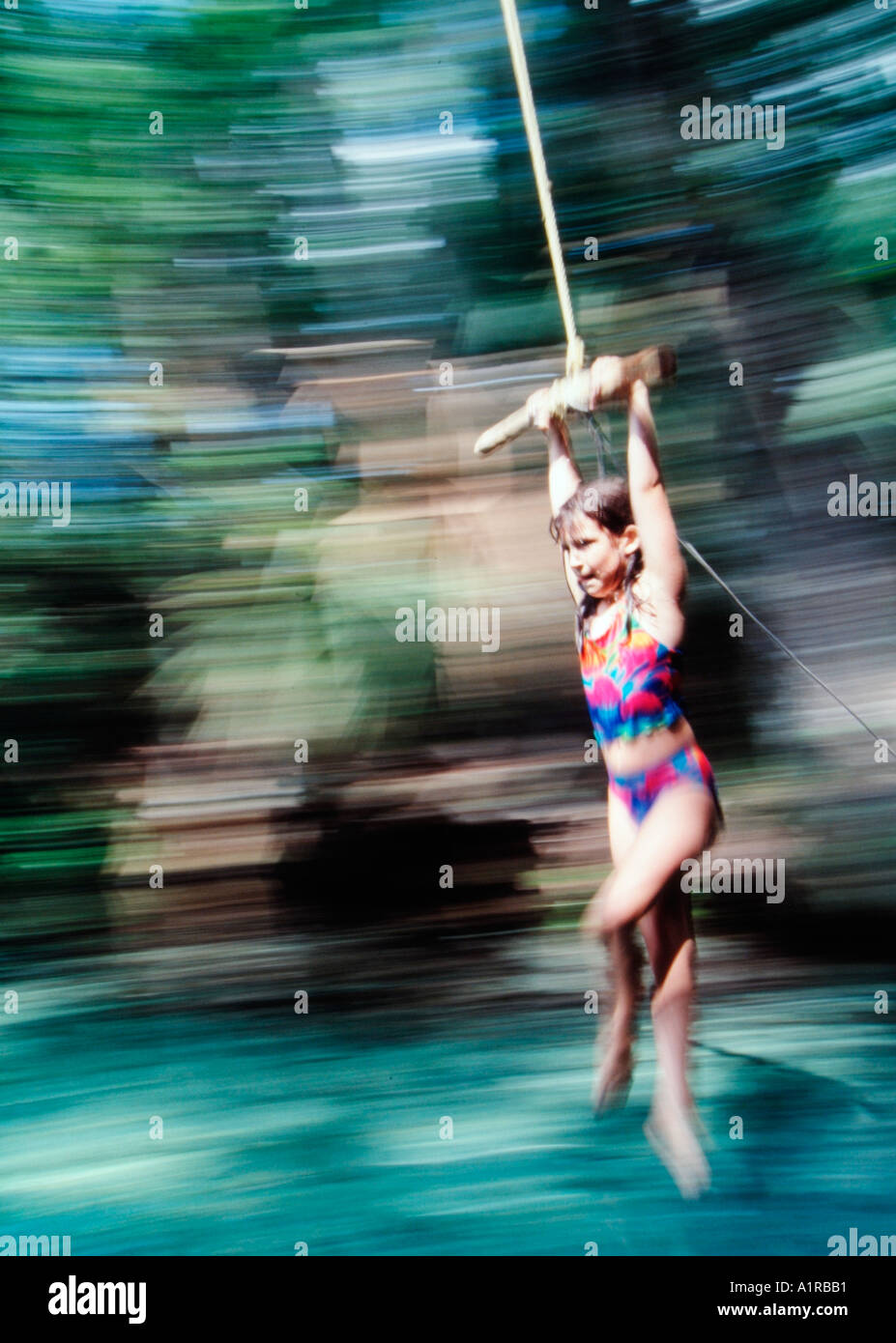 Young girl on rope swing Stock Photo - Alamy