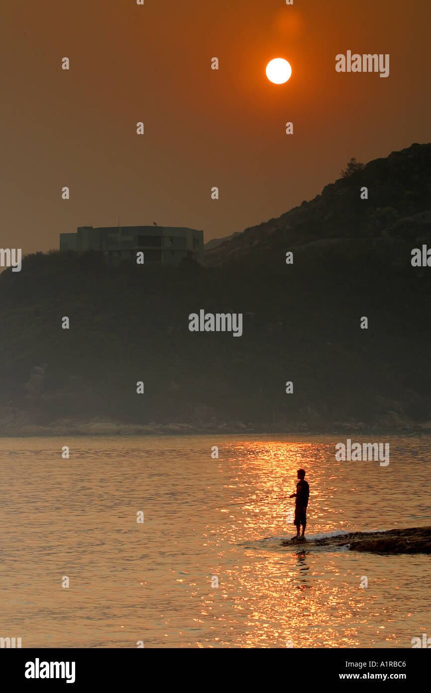 Sunset in beach seaside stone mountain sun reflect inverted image ...
