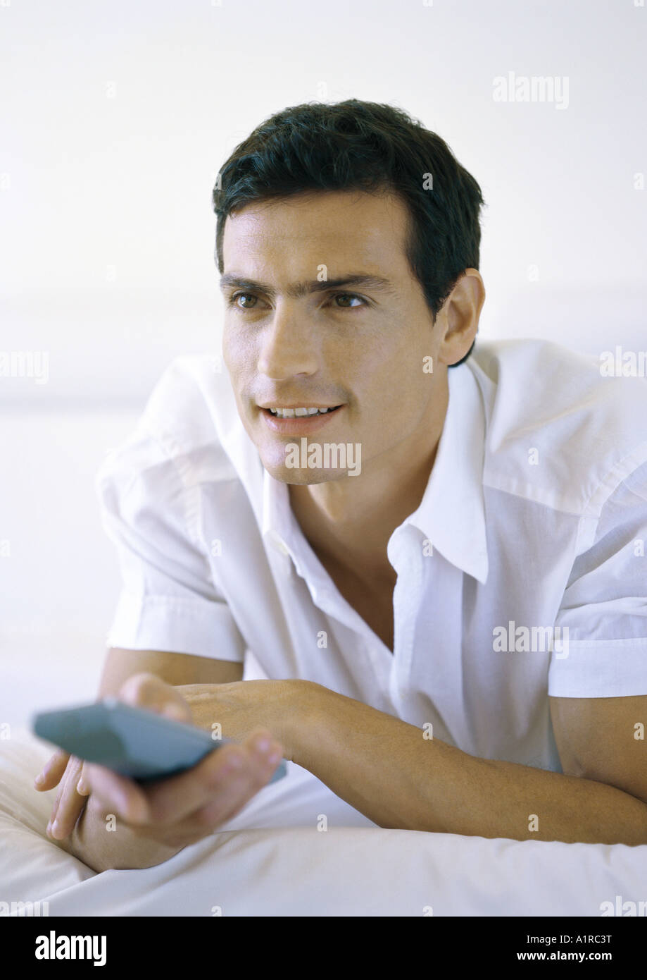 Man holding remote control Stock Photo - Alamy