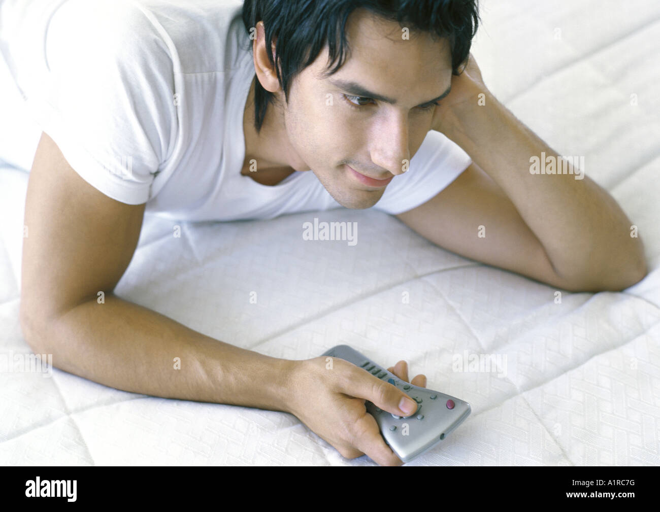 Man holding remote control Stock Photo - Alamy