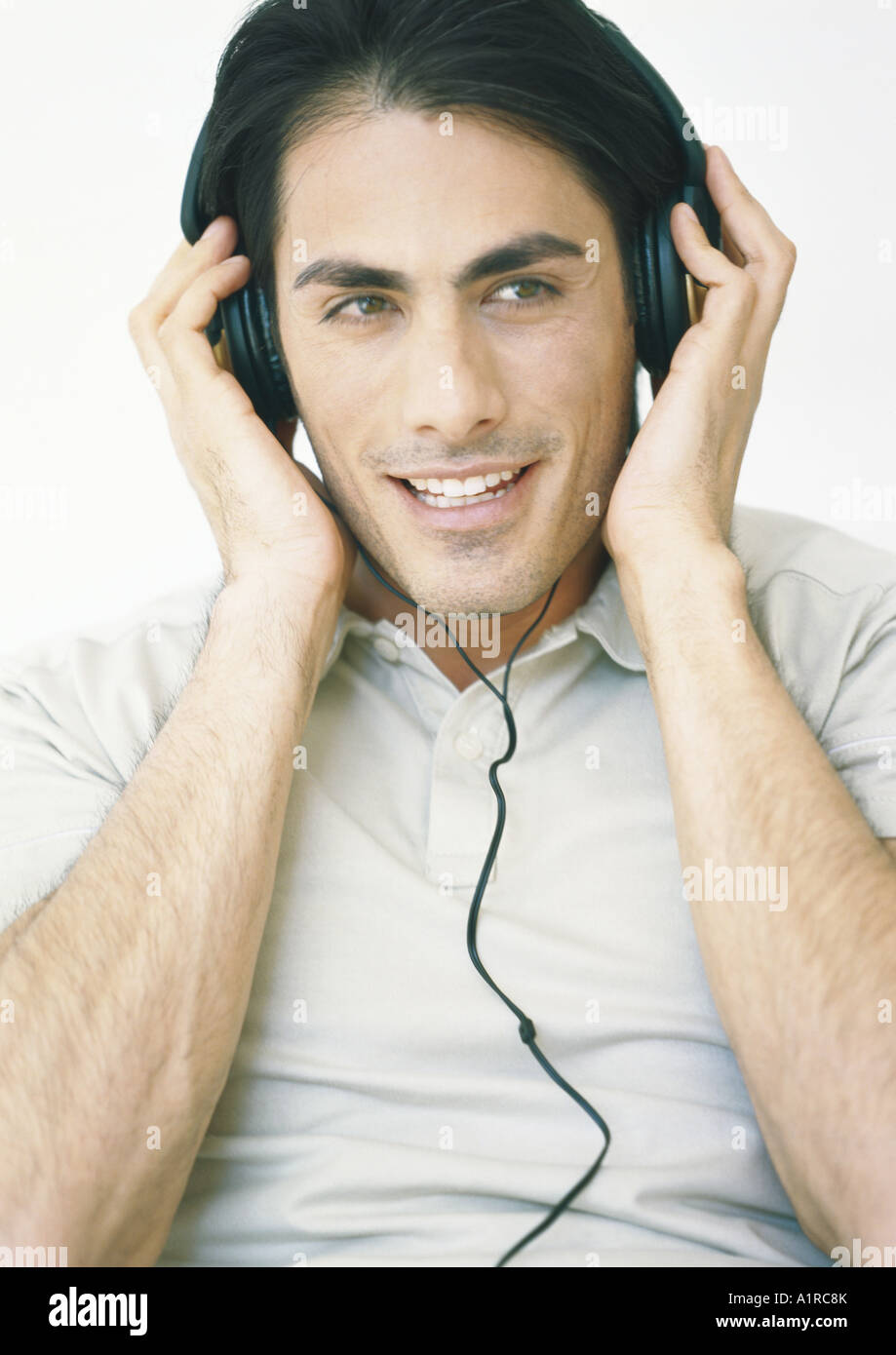 Man listening to headphones Stock Photo - Alamy