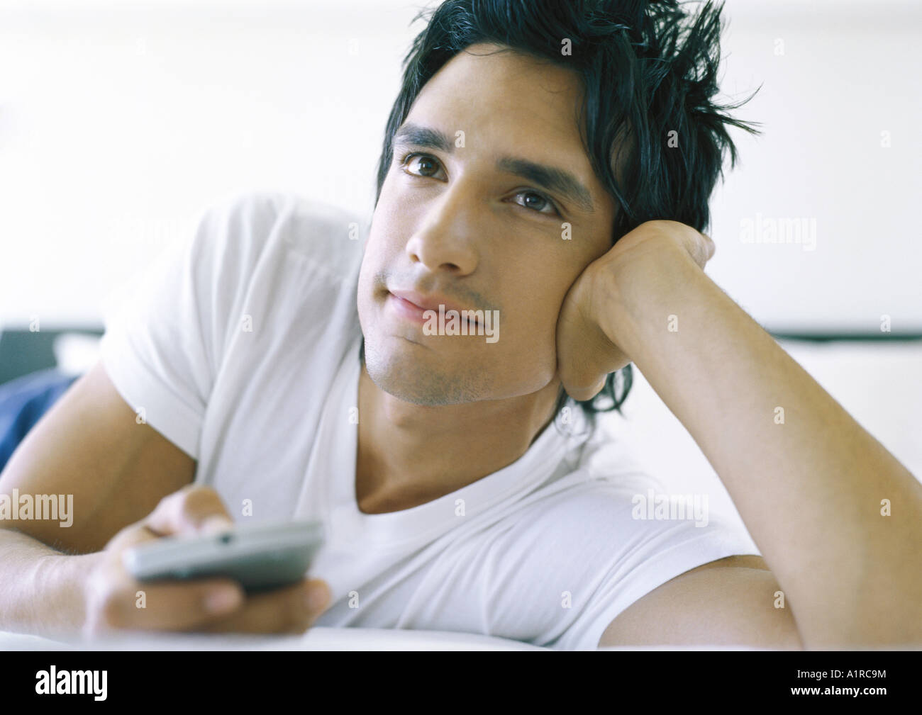 Man holding remote control Stock Photo - Alamy