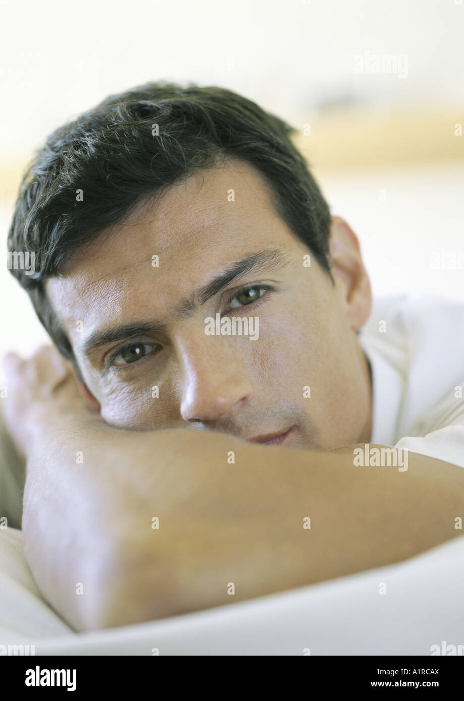 Man resting head on arm Stock Photo - Alamy