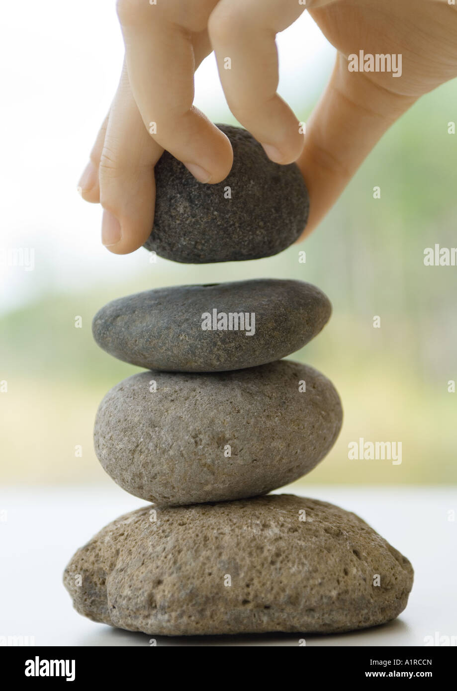 Woman stacking stones hi-res stock photography and images - Alamy