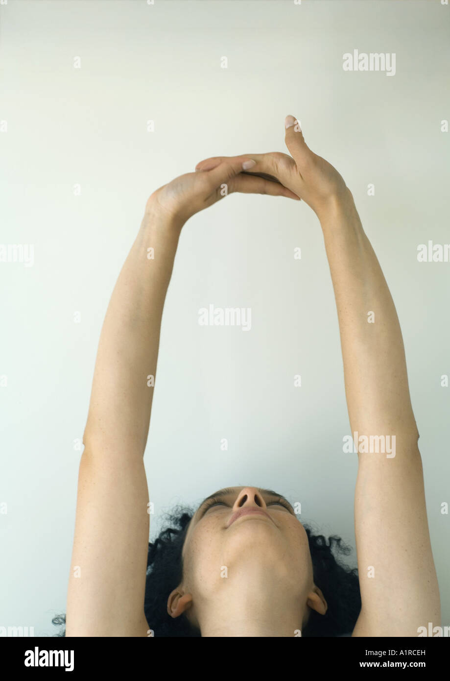 Woman stretching arms over head Stock Photo - Alamy