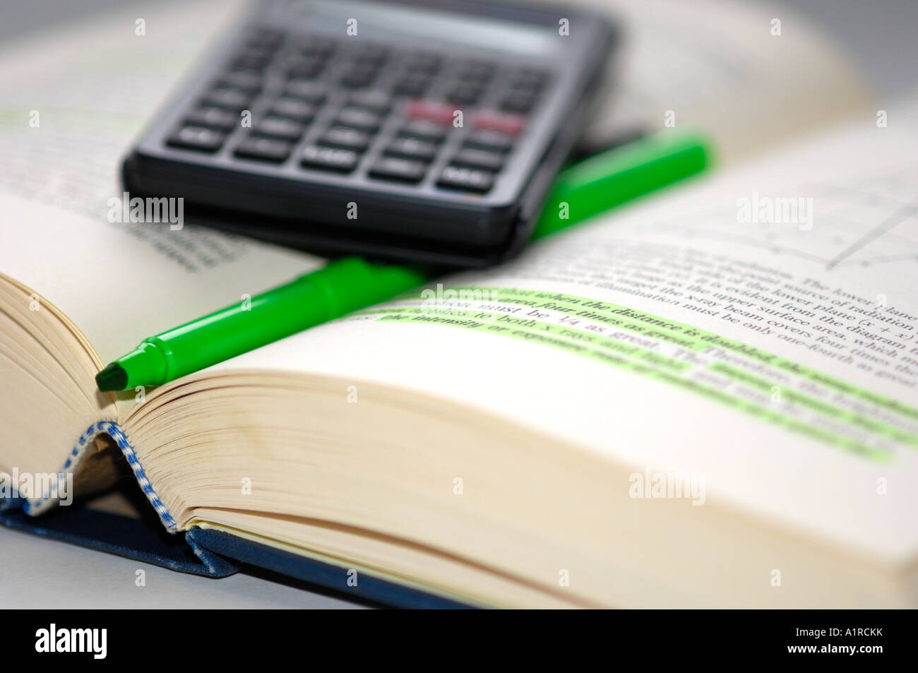 Studying text with calculator Stock Photo - Alamy