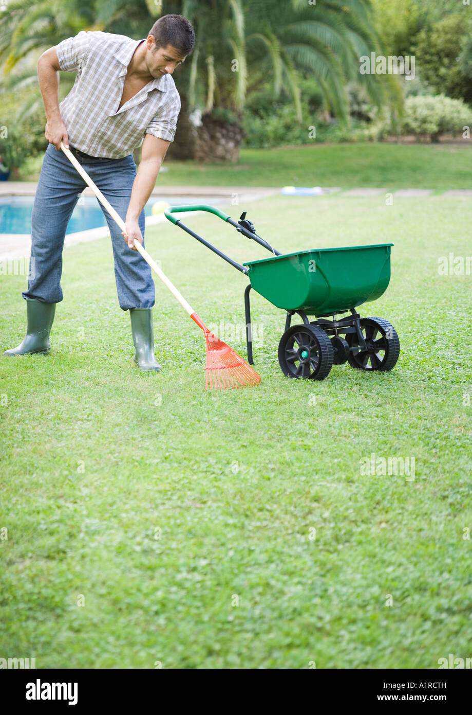 Man raking over grass hi-res stock photography and images - Alamy