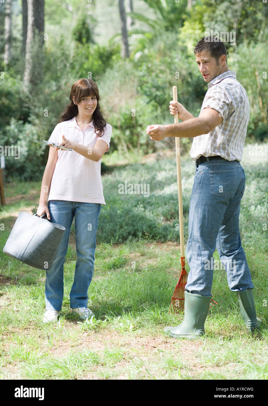 Couple doing yardwork Stock Photo - Alamy
