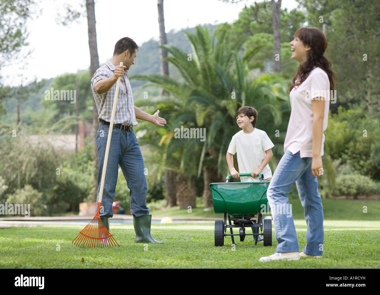 Family doing yardwork Stock Photo - Alamy