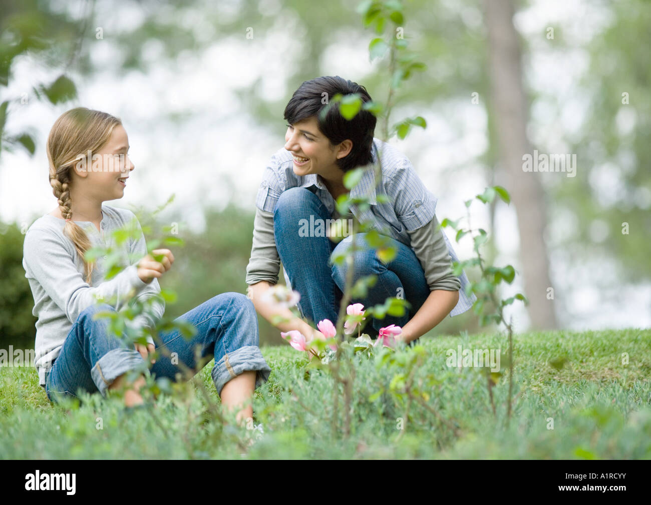 Mother and daughter doing yardwork, chatting Stock Photo - Alamy