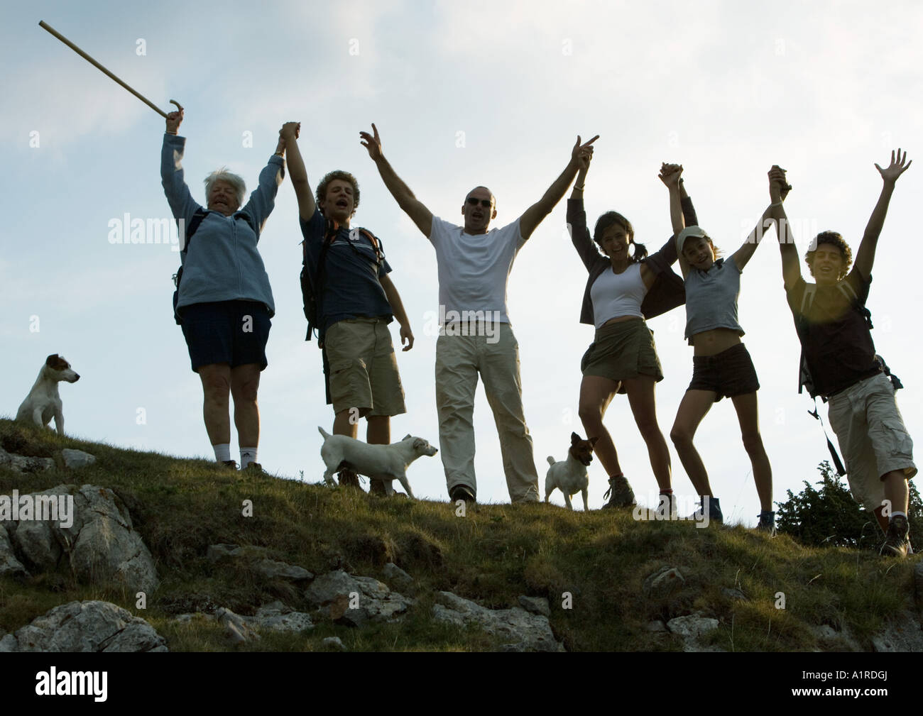 Hikers standing side by side, arms in the air Stock Photo - Alamy