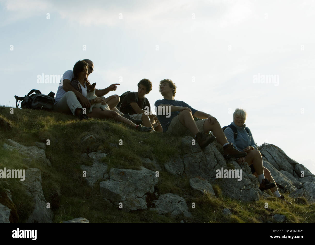 Hikers taking break, sitting on rocks Stock Photo - Alamy