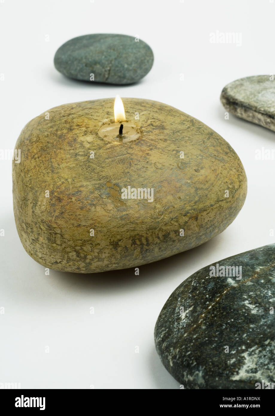 Candle and stones Stock Photo - Alamy