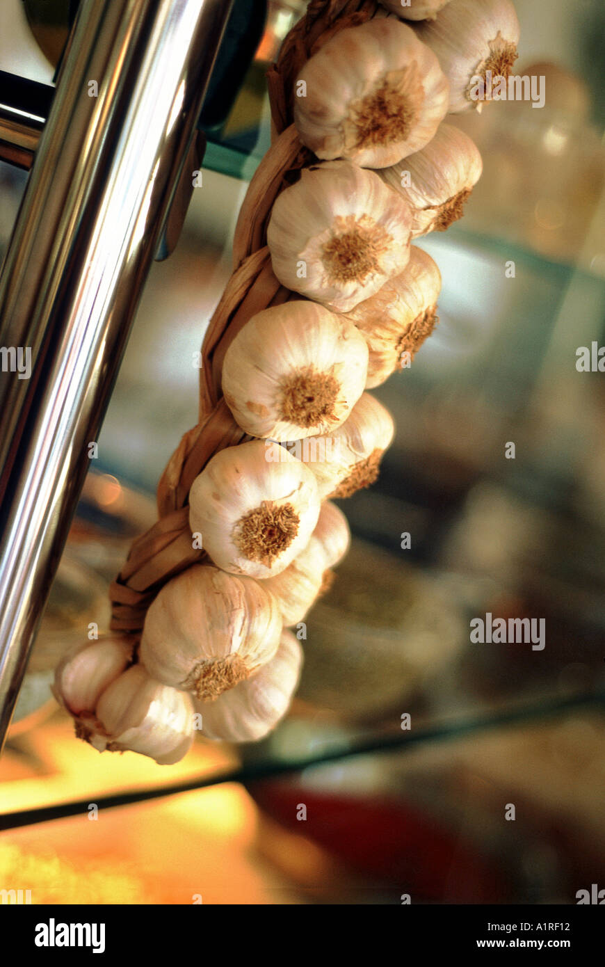 String of garlic hanging in modern kitchen Stock Photo - Alamy