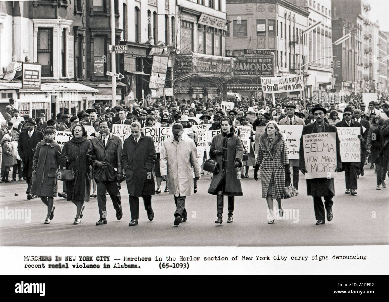 Marchers in Harlem New York City carry signs denouncing recent violence ...