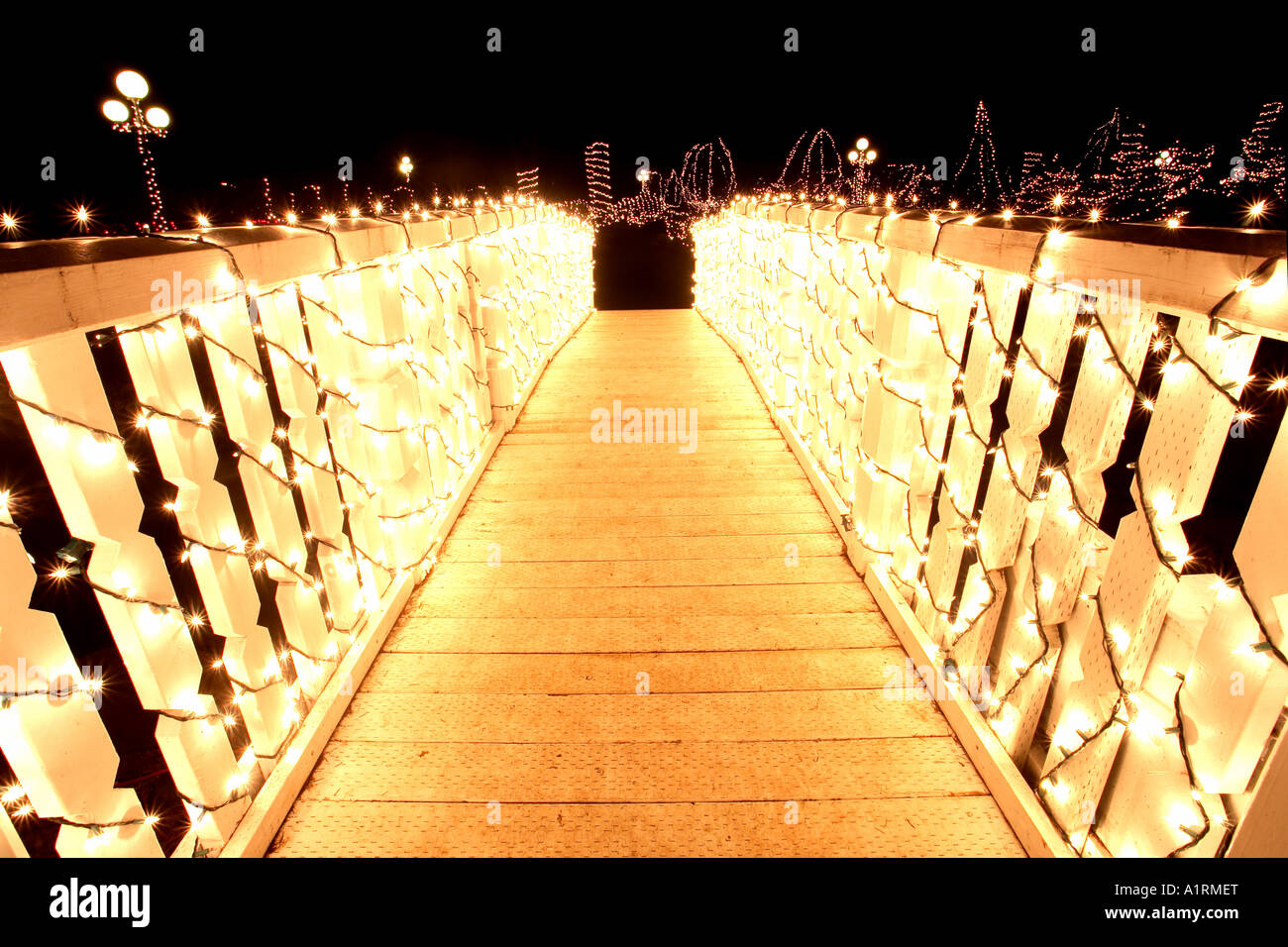 A white bridge lit with christmas lights at nigth Stock Photo - Alamy